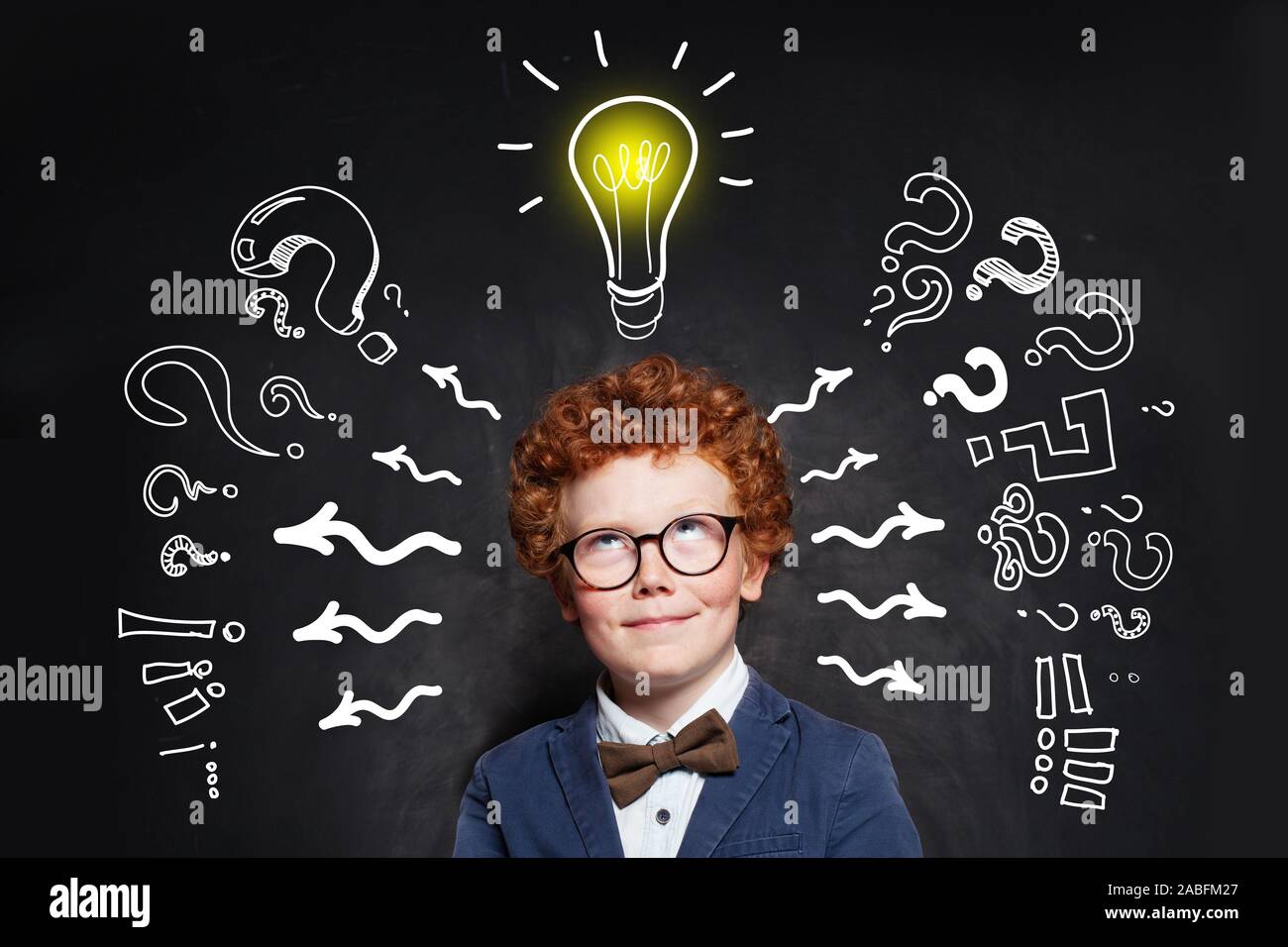 Cute school boy student with lightbulb on blackboard background Stock ...