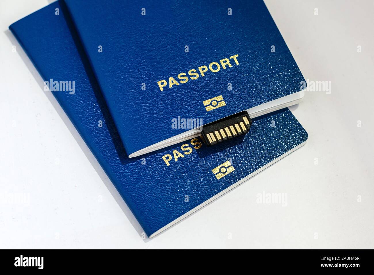 Blue passport with memory card and usb cable on a white background ...