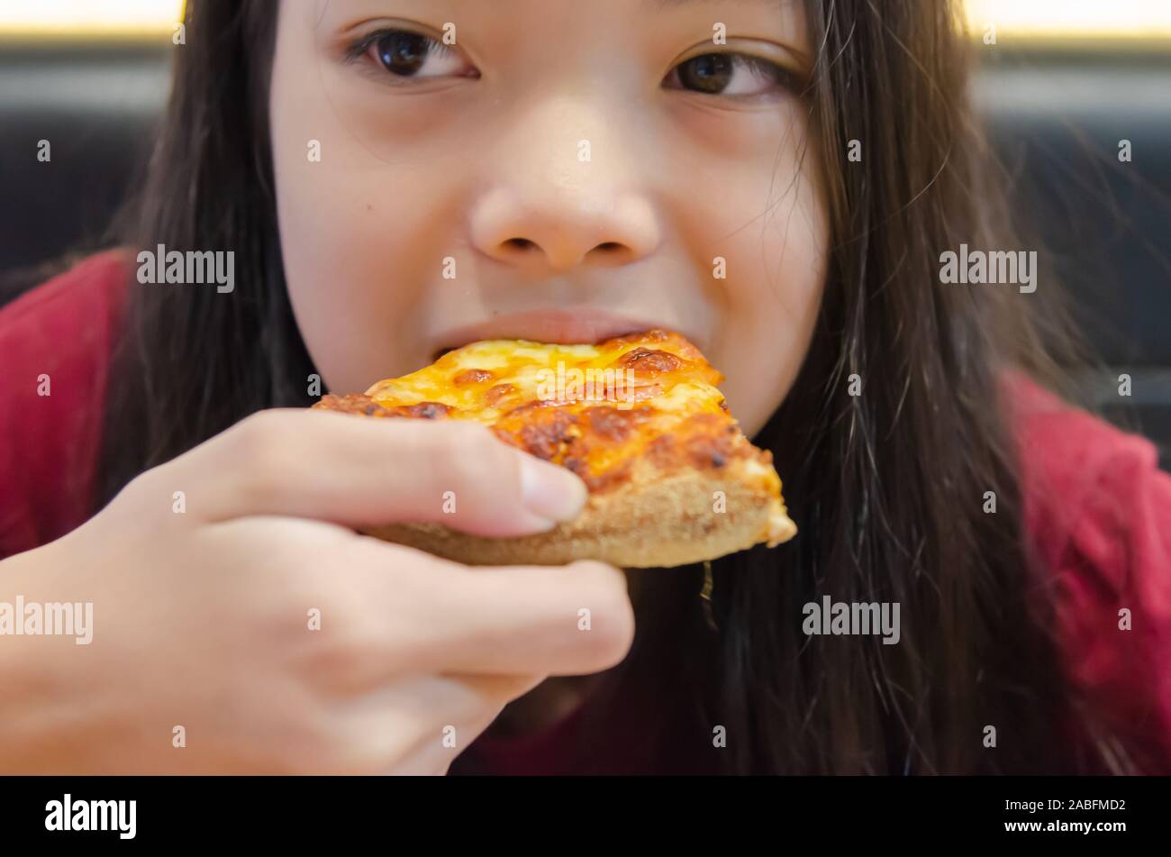Asian Child girl with long hair eat pizza Stock Photo - Alamy