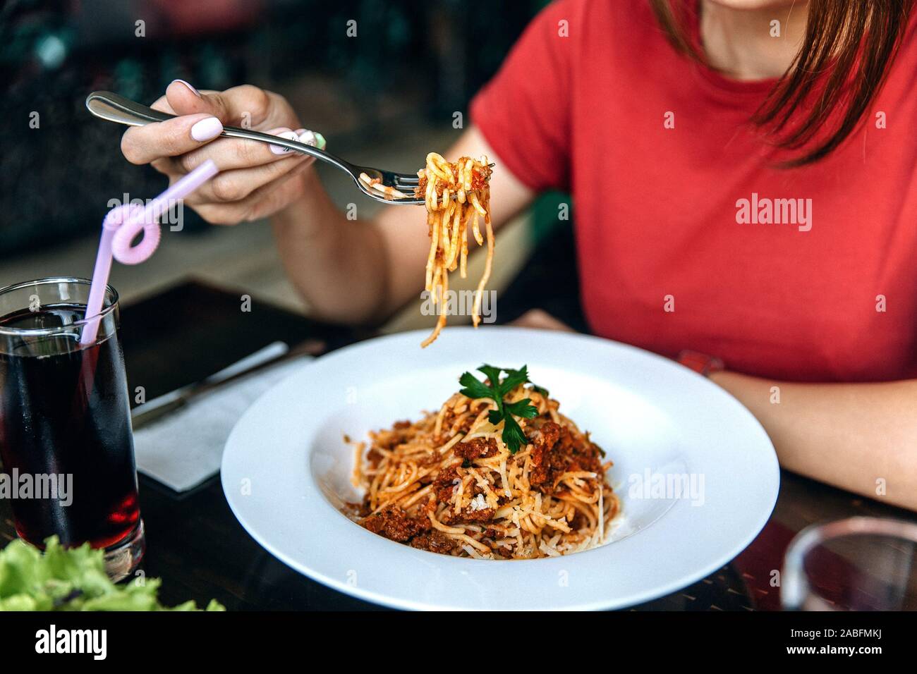 Woman eating spaghetti bolognese hi-res stock photography and images ...
