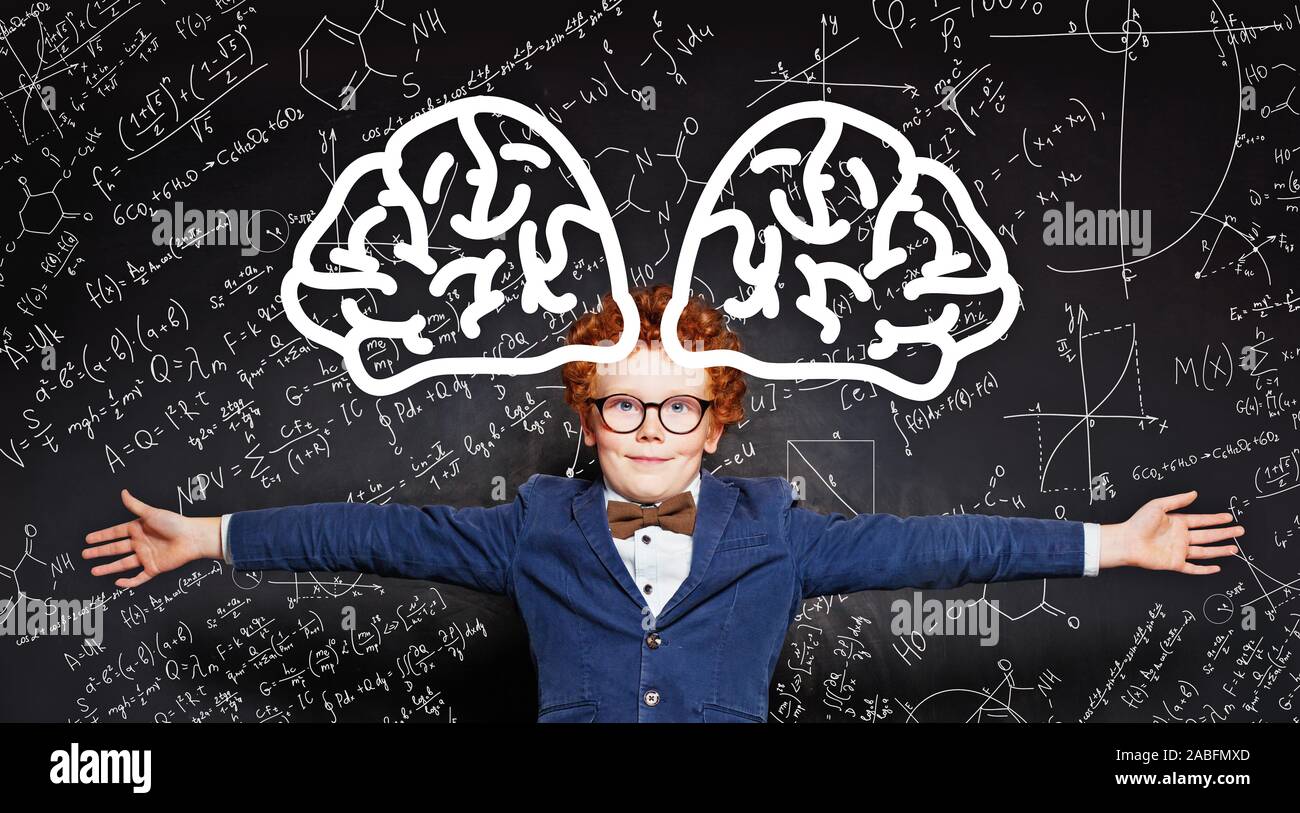 Happy kid embracing on blackboard background with science formulas and ...