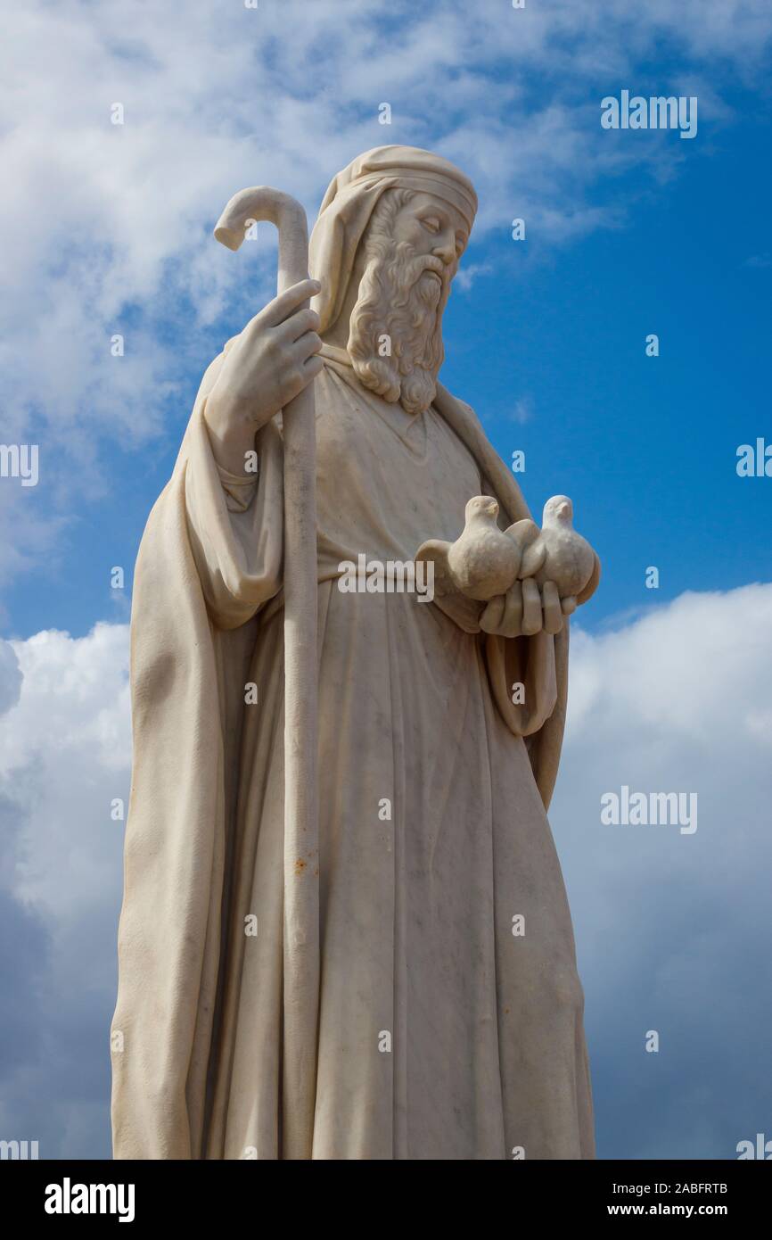 Marble statue of male figure with staff and two doves at the National ...