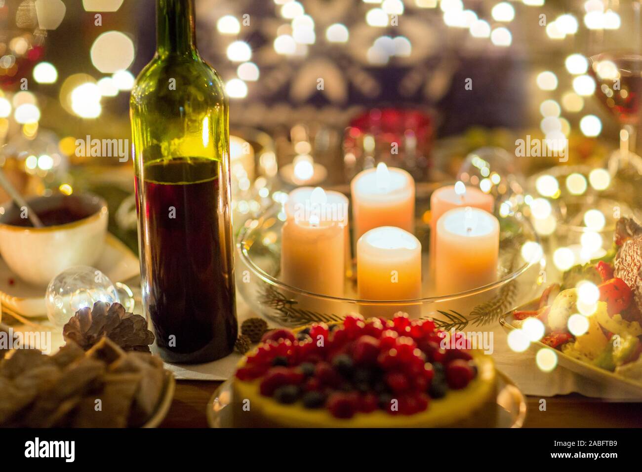 food, drinks and candles burning on table Stock Photo - Alamy