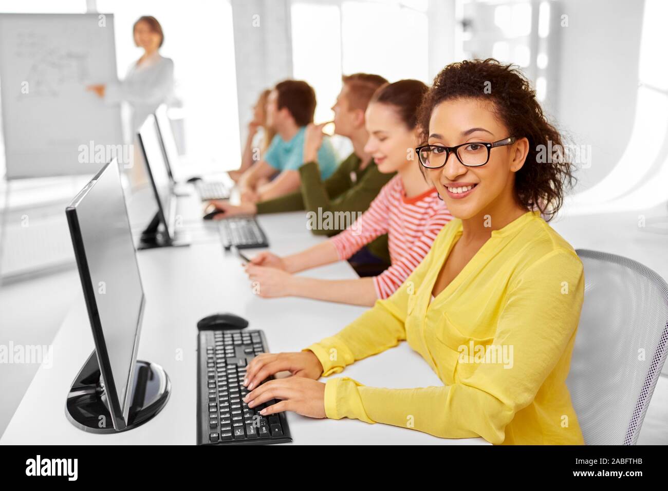 happy high school students in computer class Stock Photo - Alamy