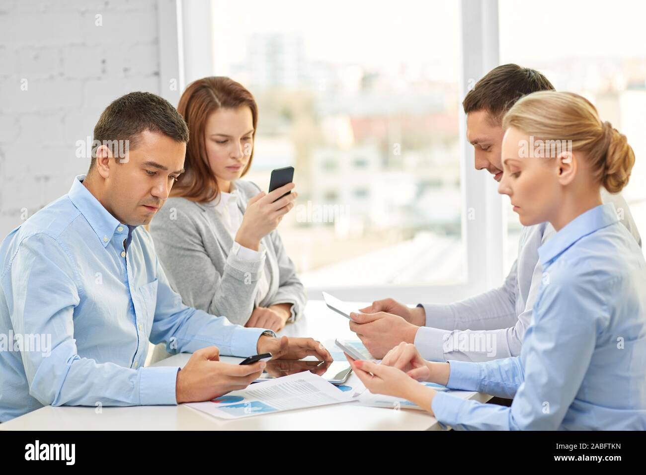 business team using smartphones at office Stock Photo - Alamy