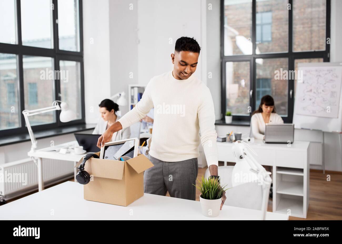 happy male office worker with personal stuff Stock Photo - Alamy