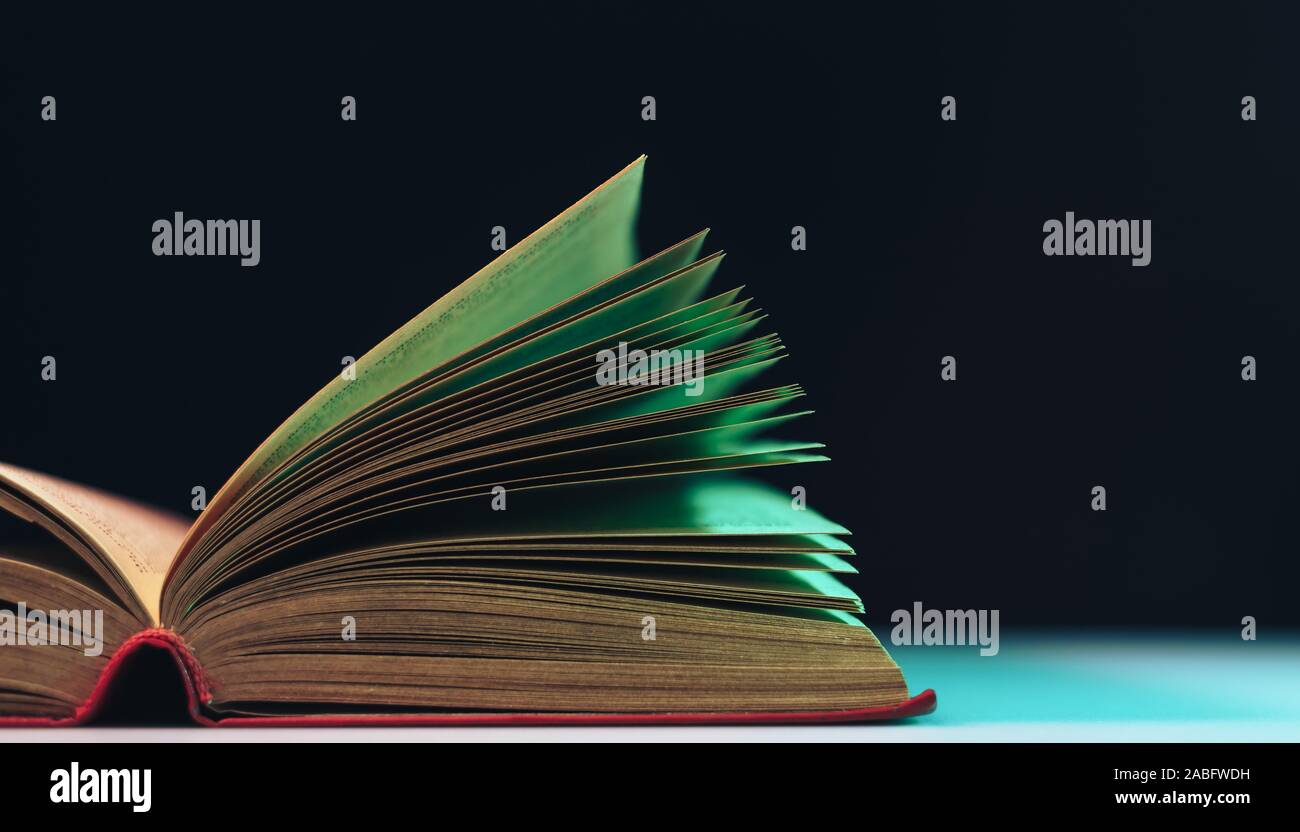 Close up Beautiful book pages in the color light on a table and night ...