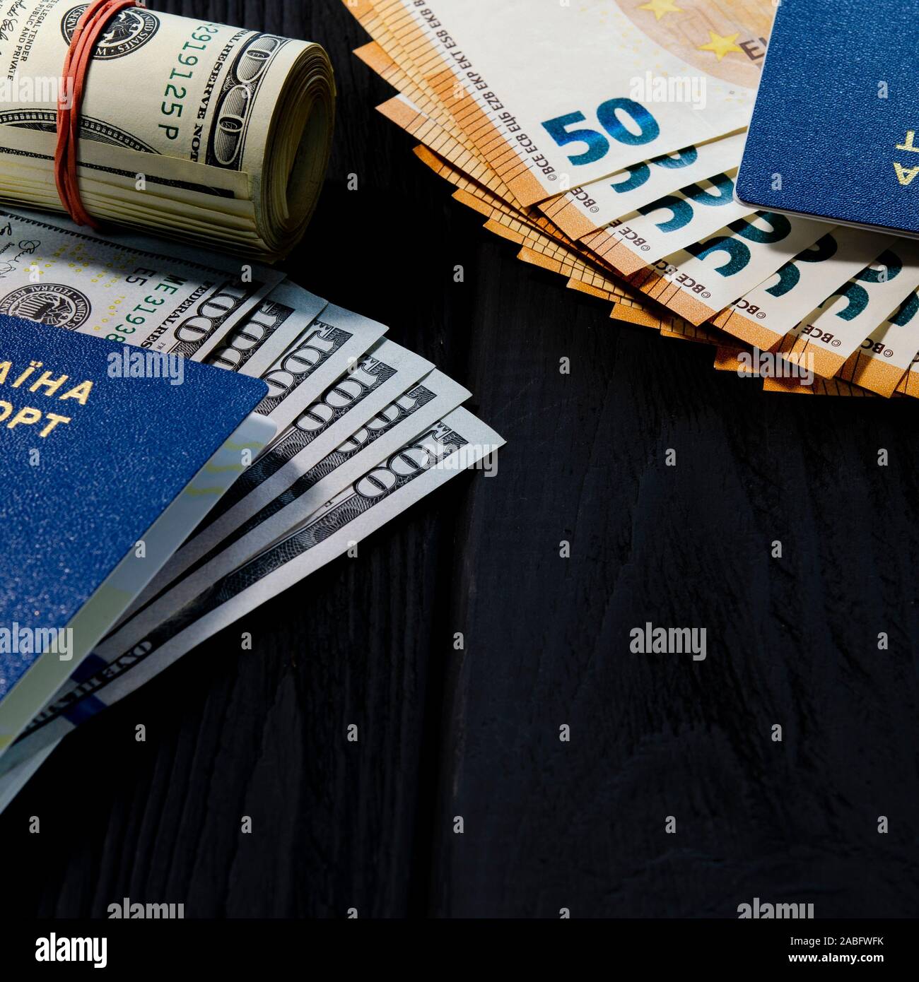 A thick roll of old hundred dollar banknotes tied a red rubber band ...