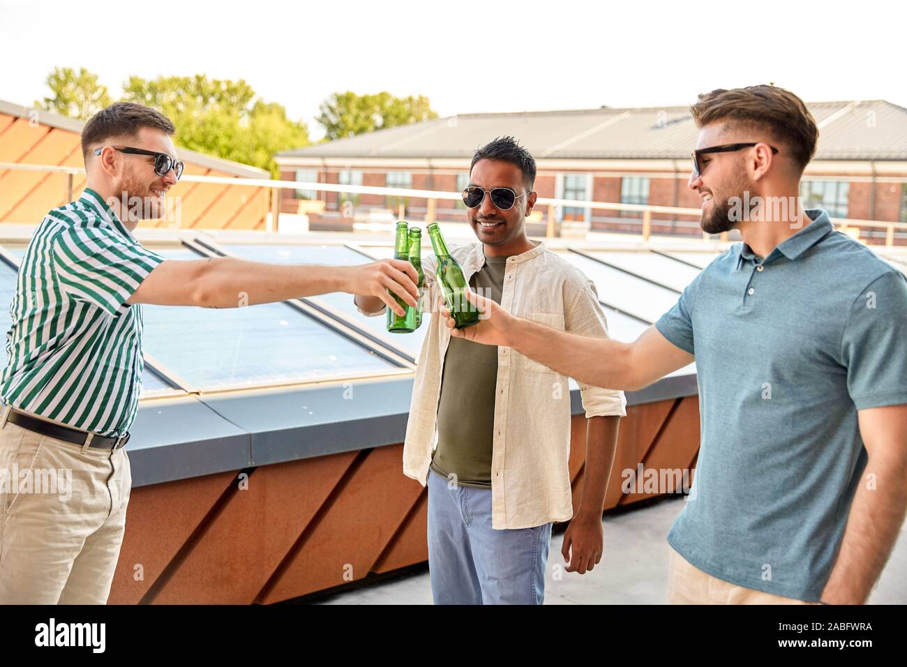 happy male friends drinking beer at rooftop party Stock Photo - Alamy