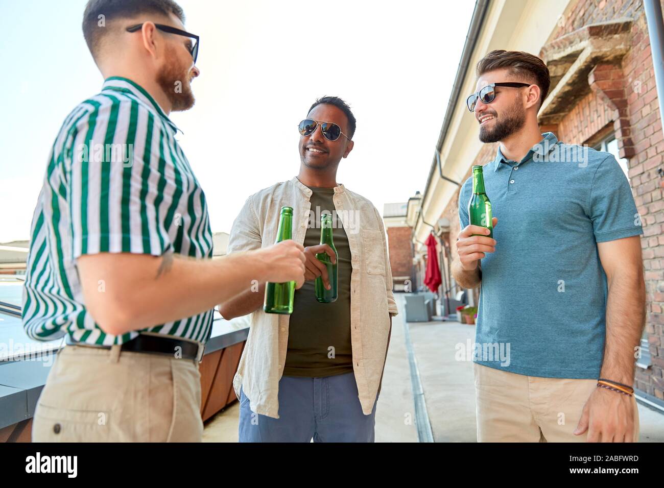 happy male friends drinking beer at rooftop party Stock Photo - Alamy