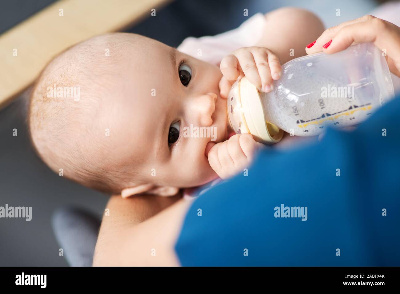 Closeup baby girl drinking milk hi-res stock photography and images - Alamy
