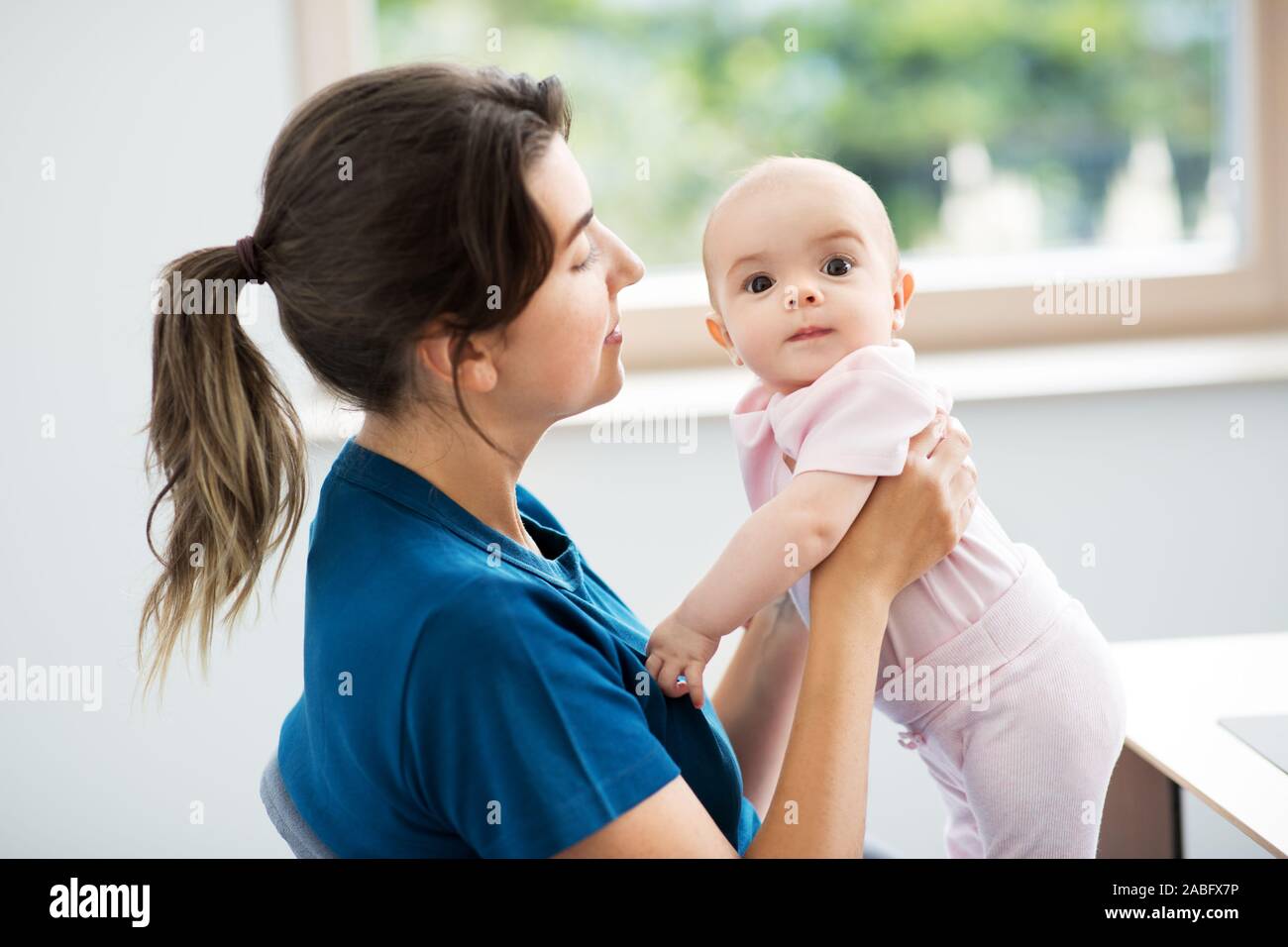 mother holding baby daughter at home Stock Photo - Alamy mother holding baby daughter at home Stock Photo - Alamy