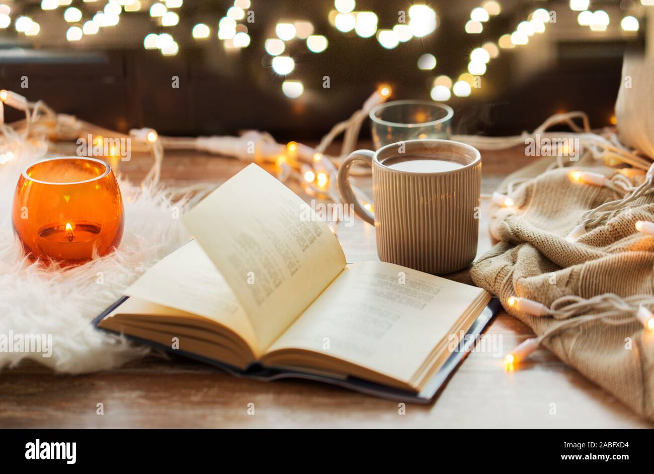 book and coffee or hot chocolate on window sill Stock Photo - Alamy