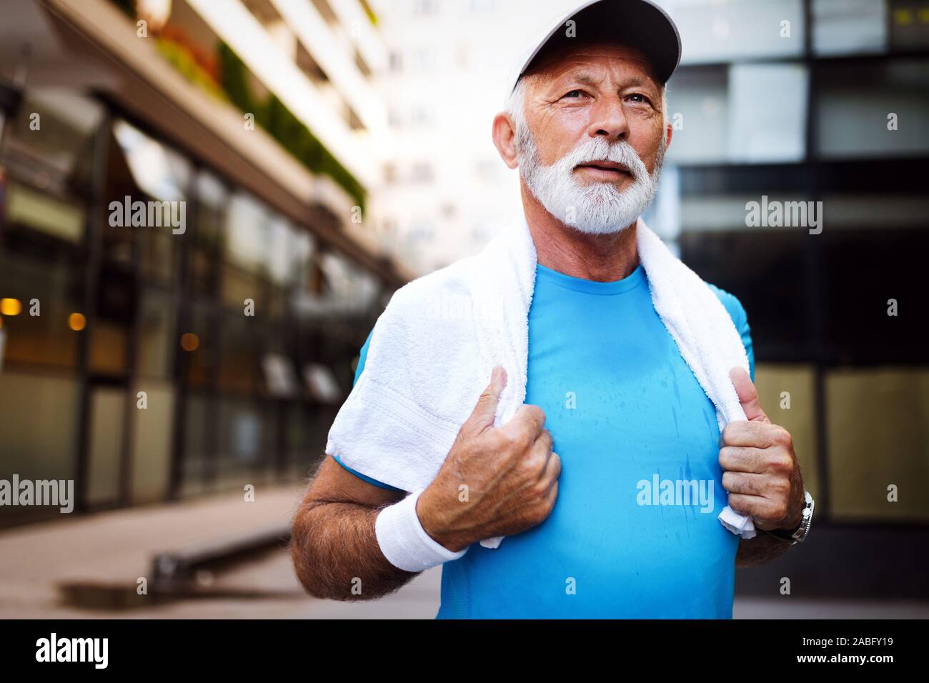 Portrait of athletic mature man after run. Handsome senior man resting ...