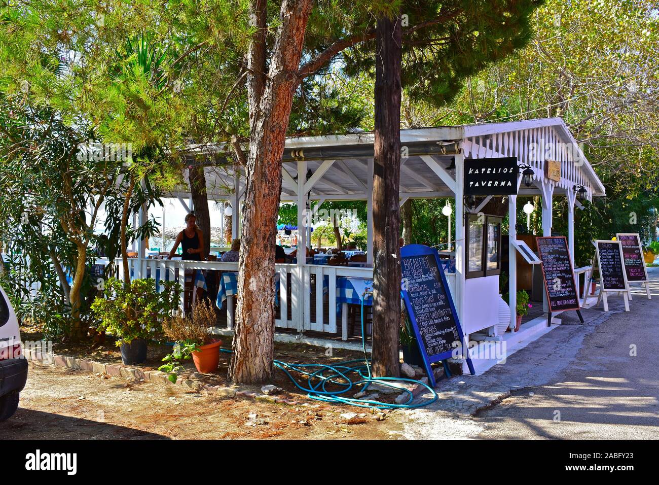 Street view of outdoor taverna restaurant /café overlooking the sea in ...