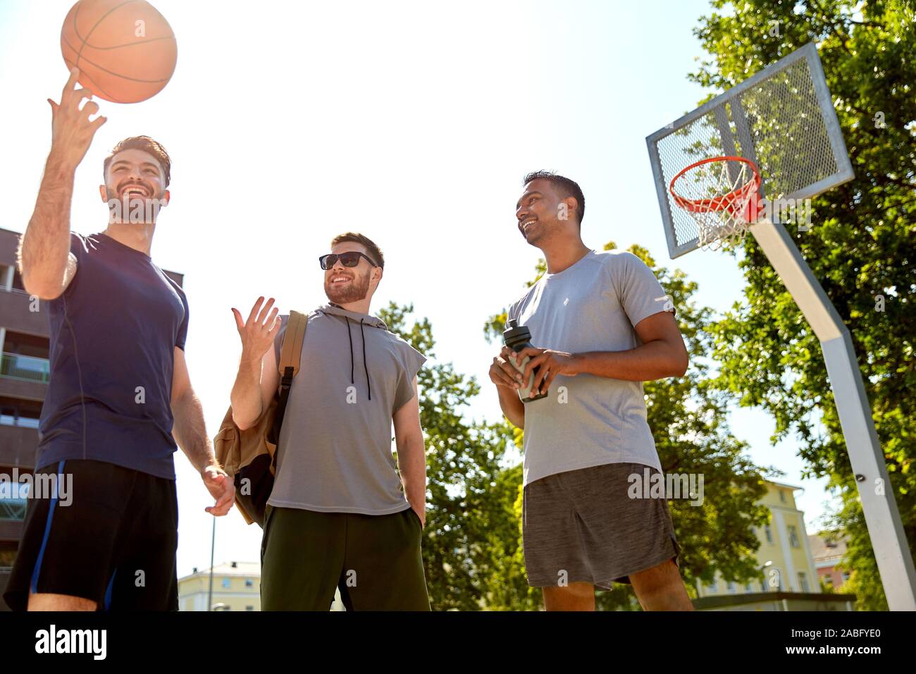 group of male friends going to play basketball Stock Photo - Alamy