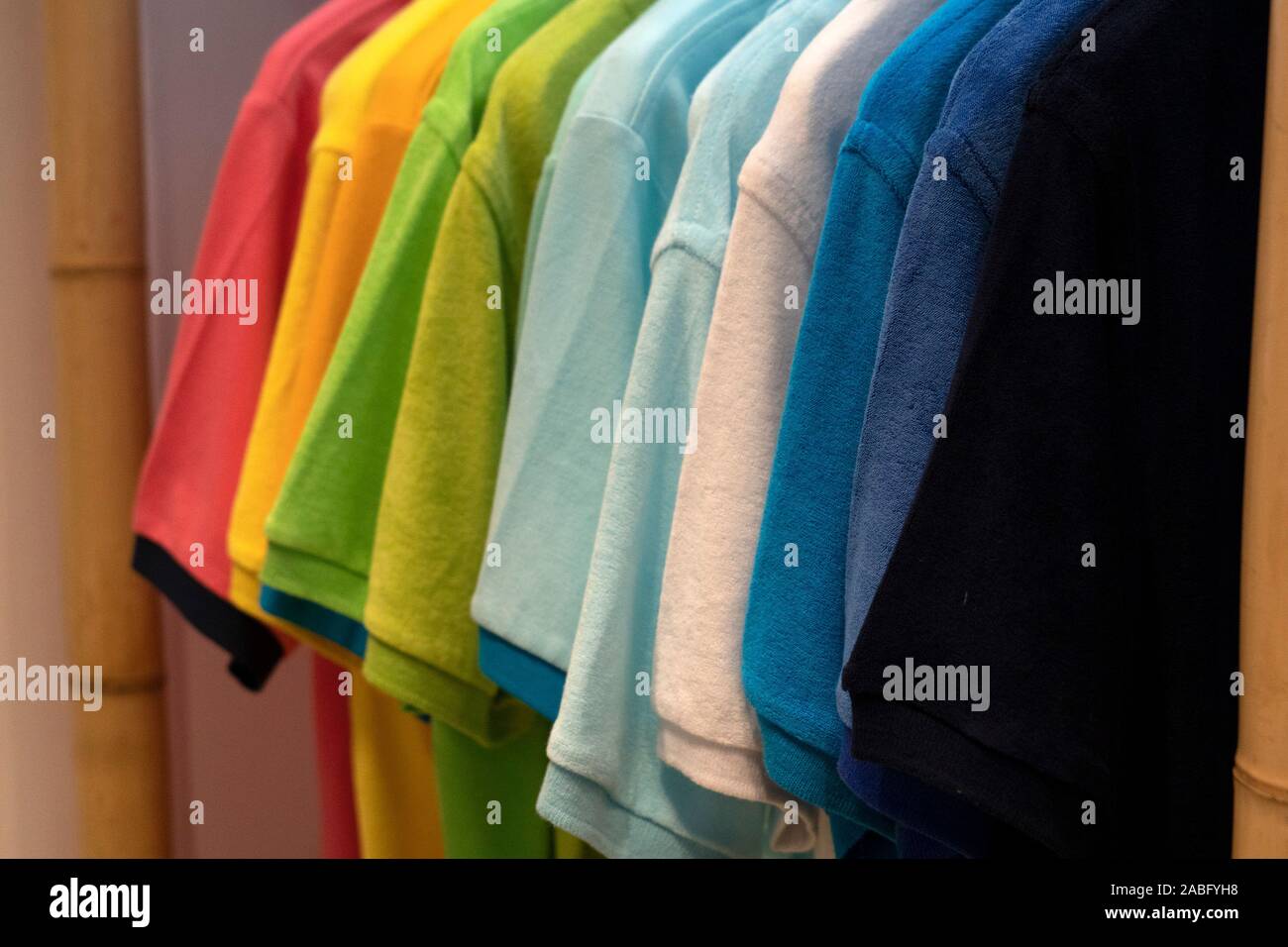 different colors polo shirt on display stand Stock Photo - Alamy