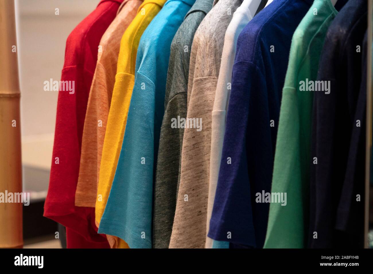 different colors polo shirt on display stand Stock Photo - Alamy