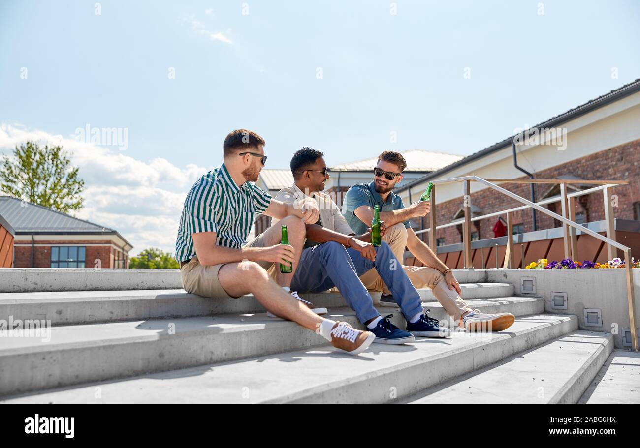 happy male friends drinking beer on street Stock Photo - Alamy