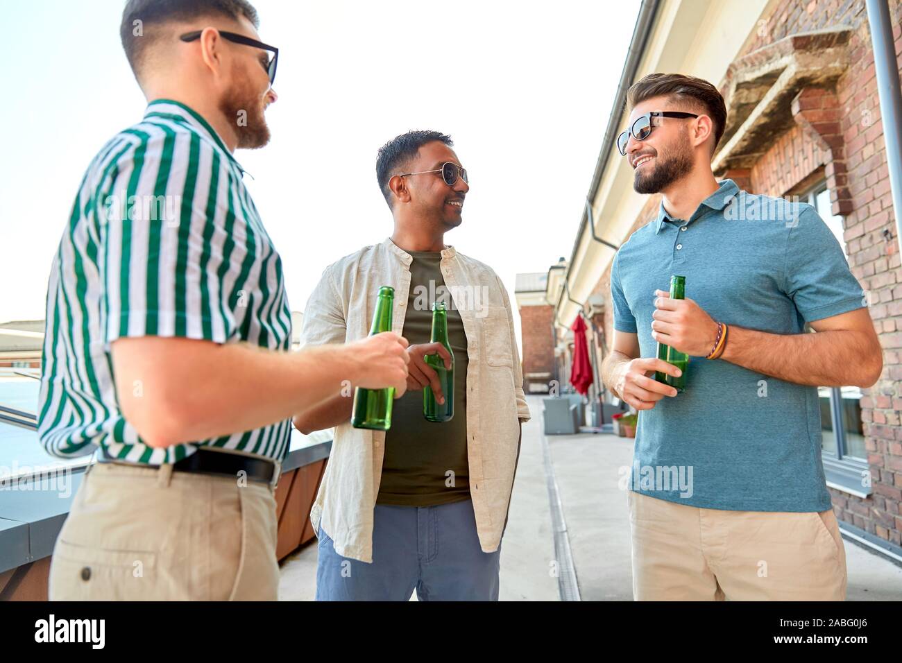 happy male friends drinking beer at rooftop party Stock Photo - Alamy