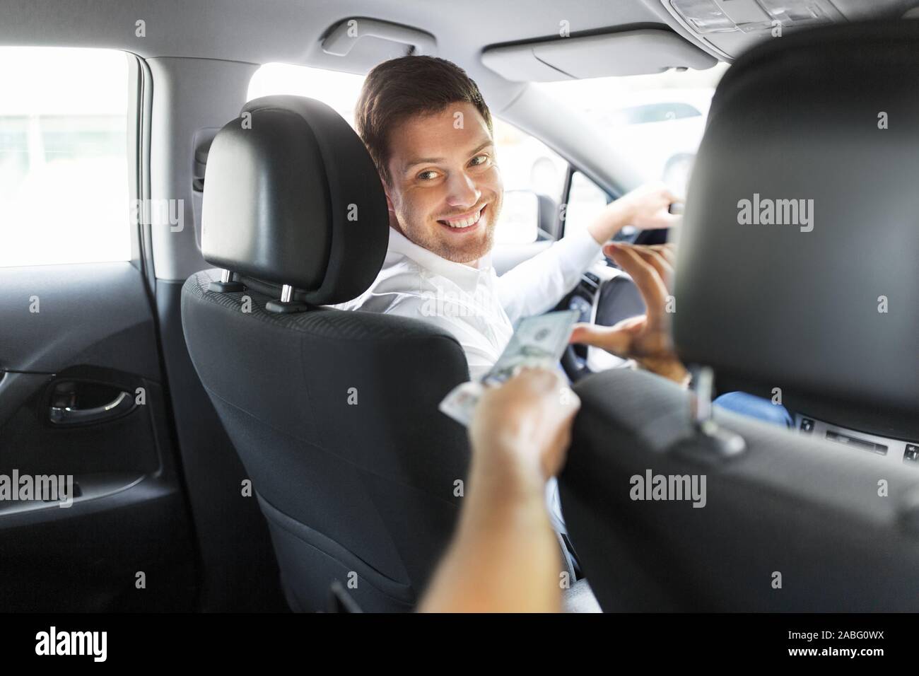 male car driver taking money from passenger Stock Photo - Alamy
