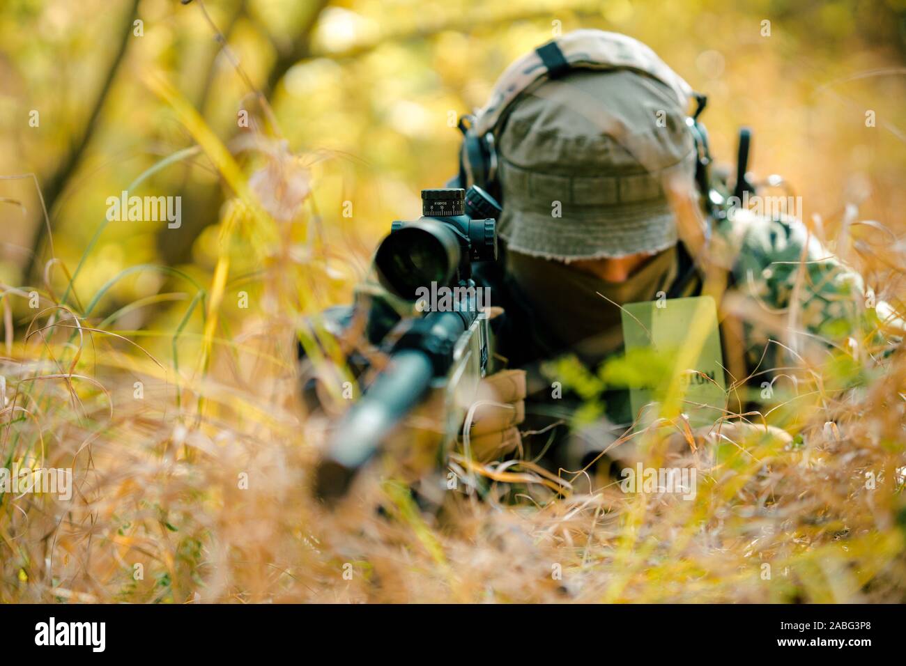 Airsoft man in uniform with machine gun and night-vision device on ...