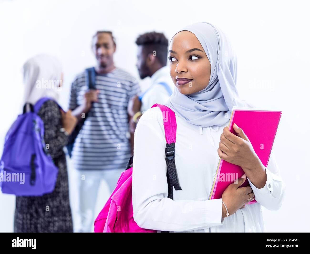 portrait of young african modern muslim female student with group of ...