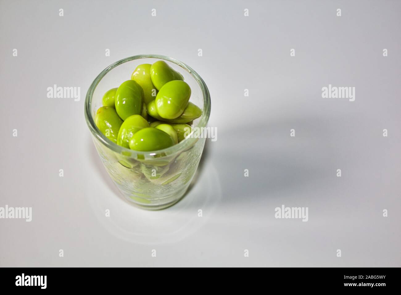 Green soybeans in a small glass container Stock Photo - Alamy