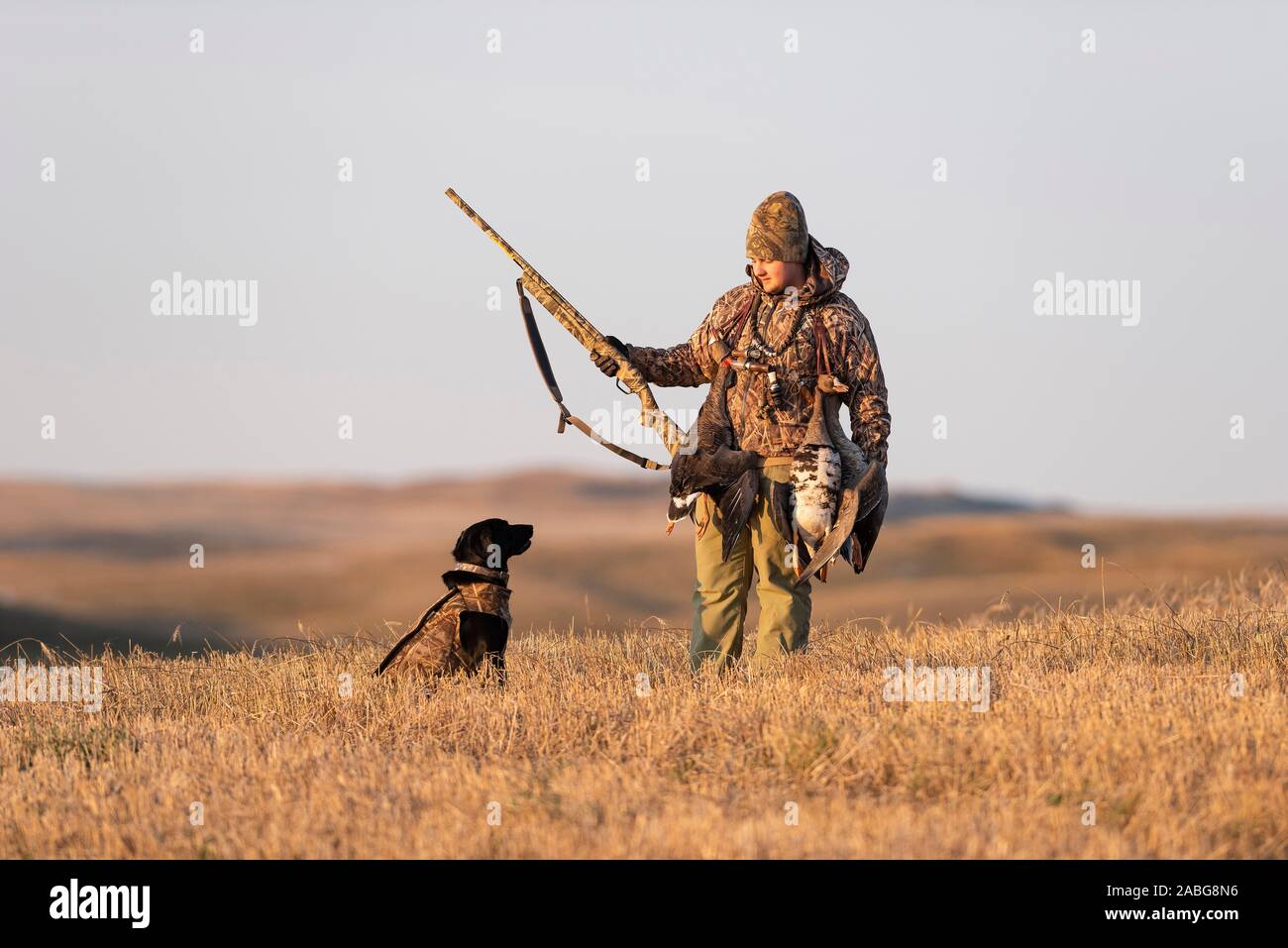 A Young Goose hunter with his Black Labrador Retriever Stock Photo - Alamy