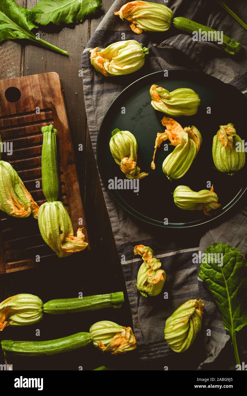Fresh raw zucchini (courgette) with flowers and Squash blossoms , on a ...