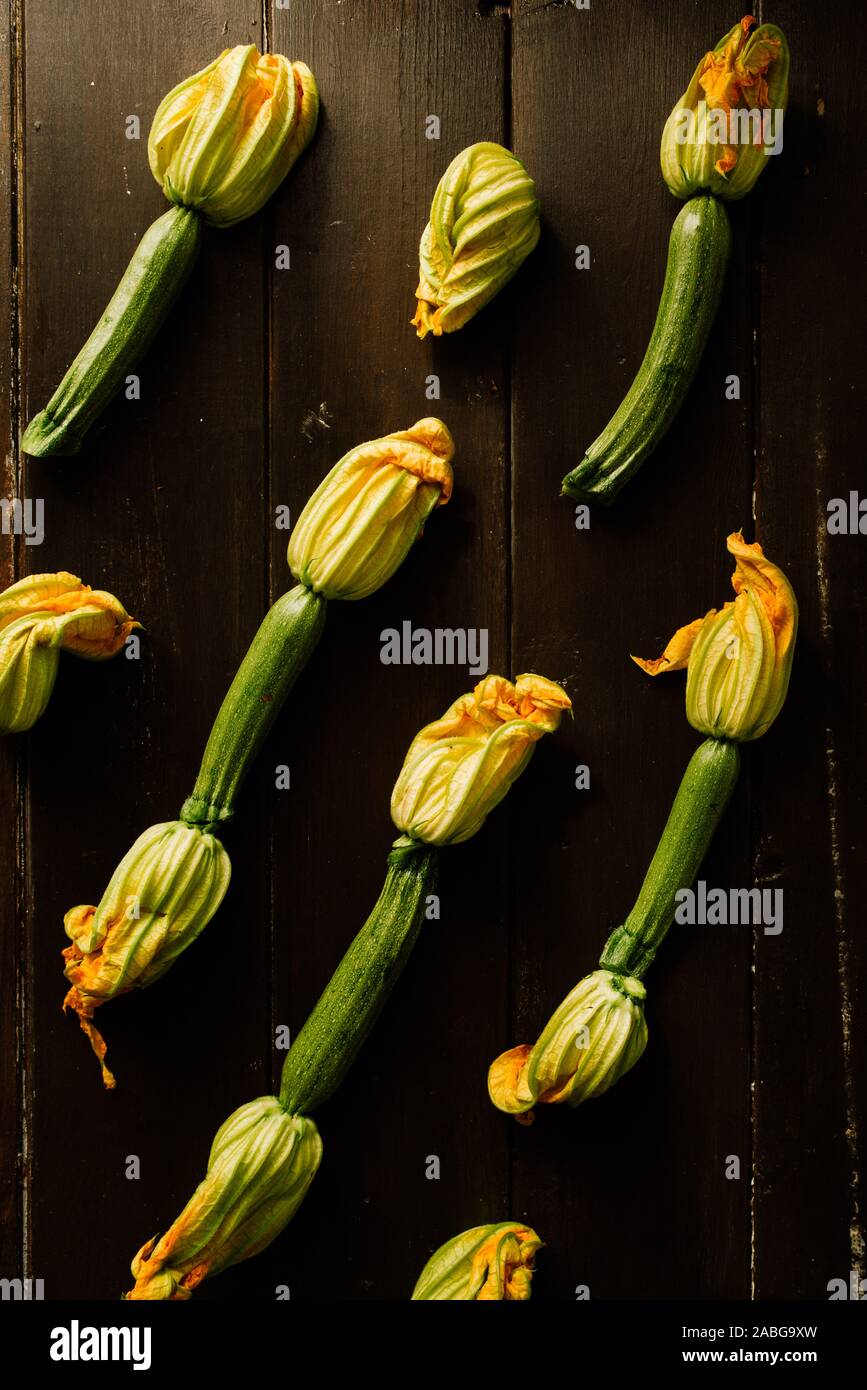 Fresh raw zucchini (courgette) with flowers and Squash blossoms , on a ...