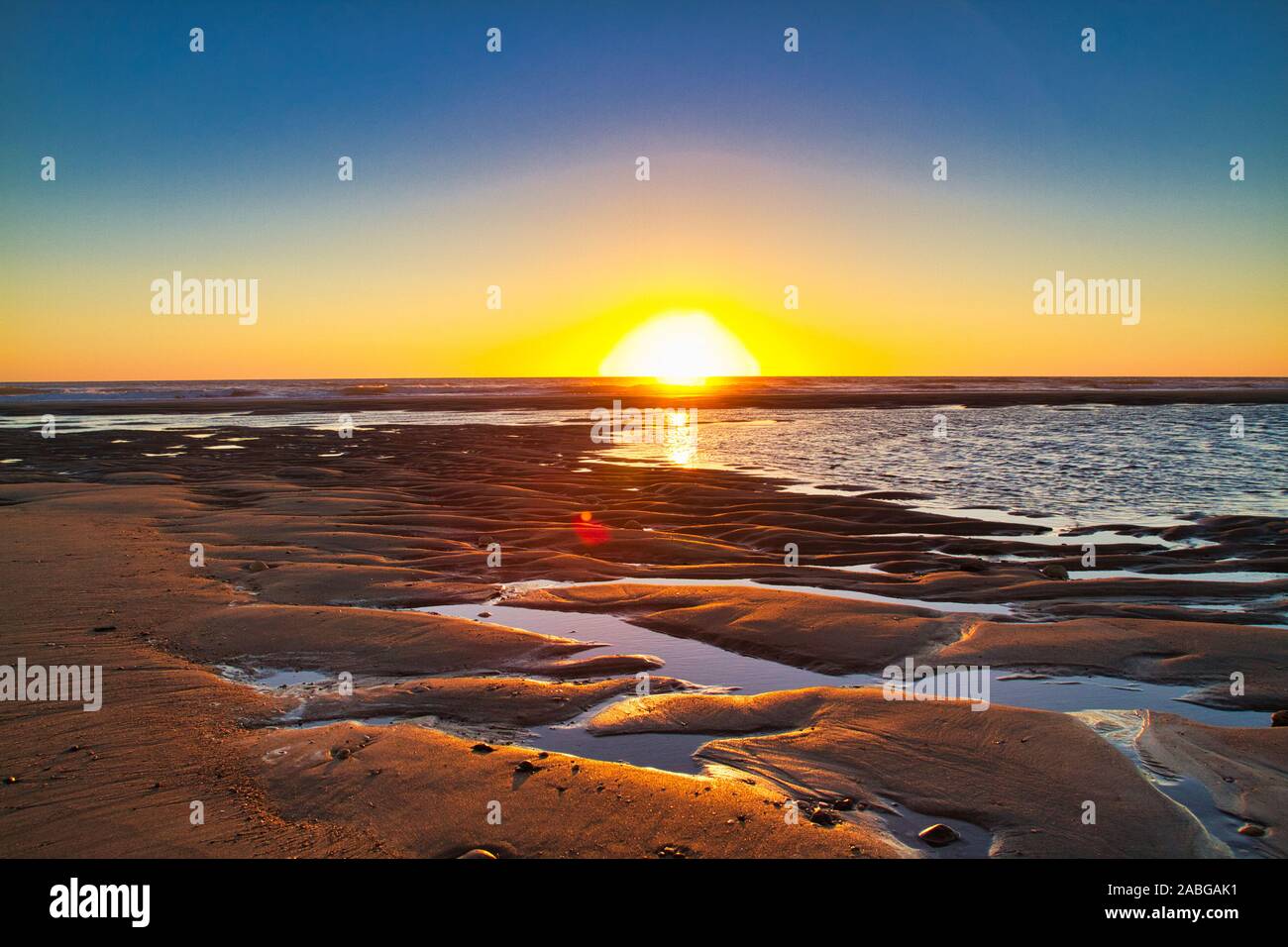 The beautiful sunset of the Atlantic Ocean on the French coast. A blue ...