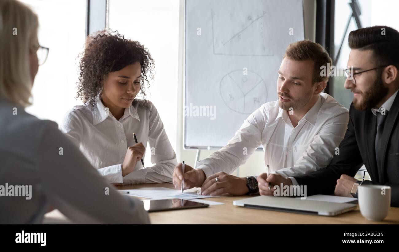 Diverse colleagues brainstorm sharing ideas at team meeting Stock Photo ...