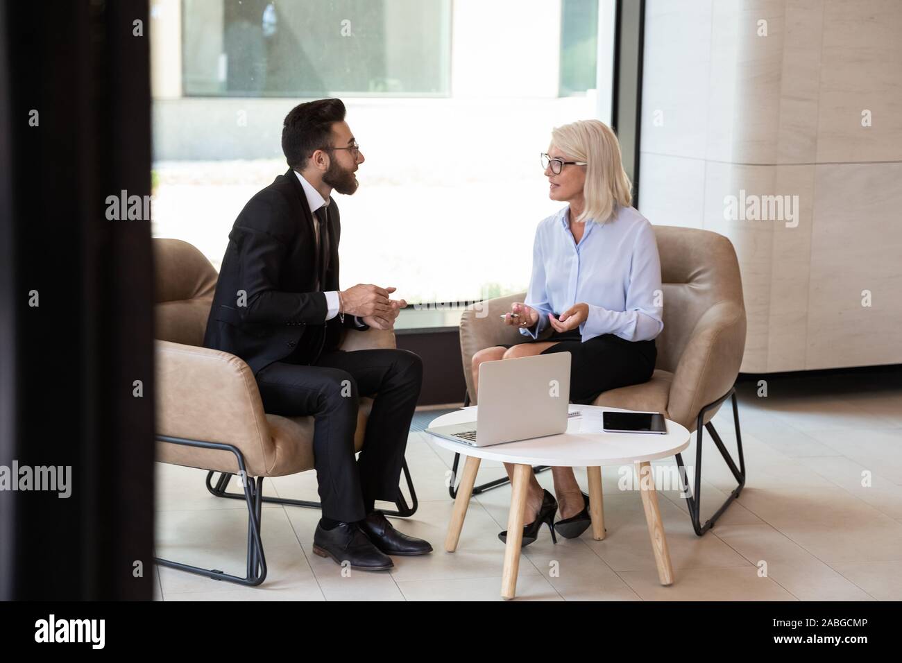 Multiracial diverse businesspeople talk discussing cooperation at ...