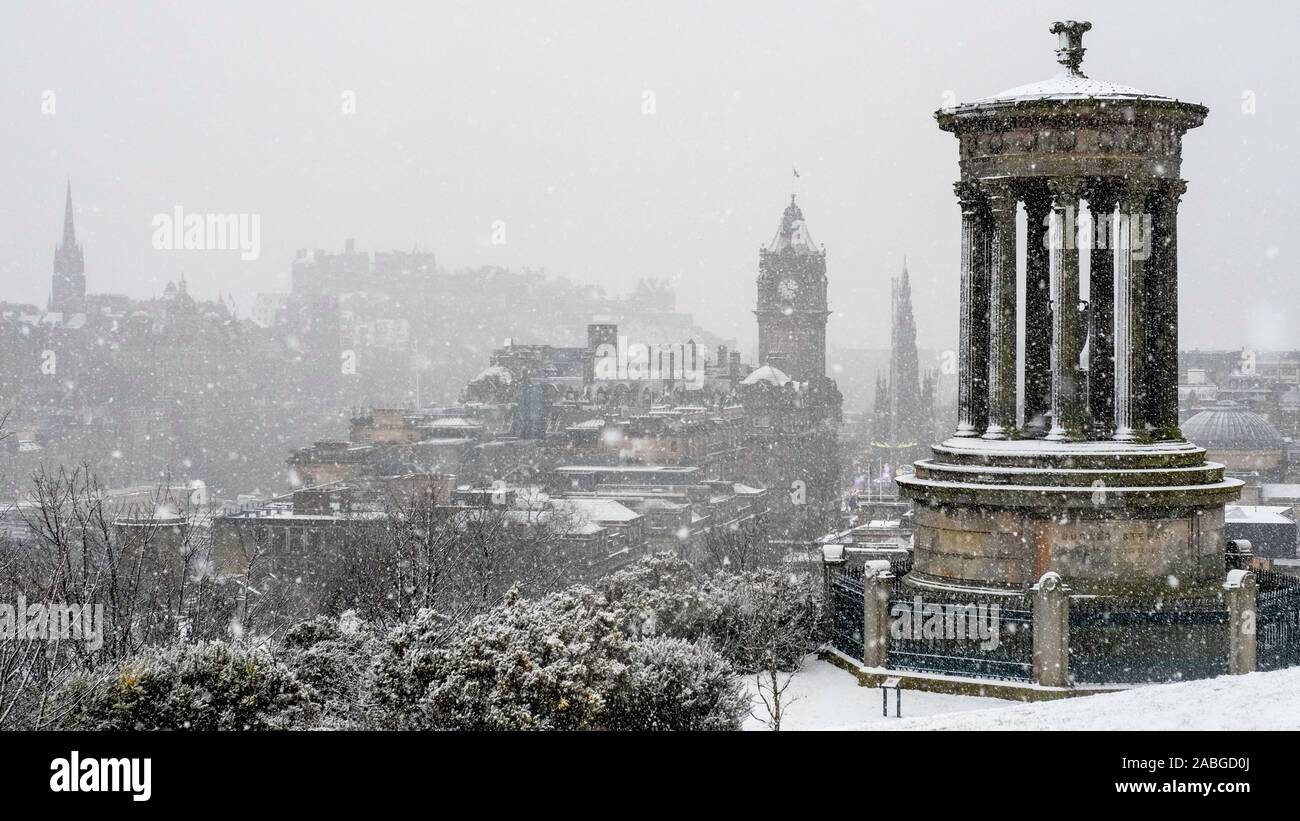 Snow falls on city of Edinburgh in December. Skyline view of city from ...