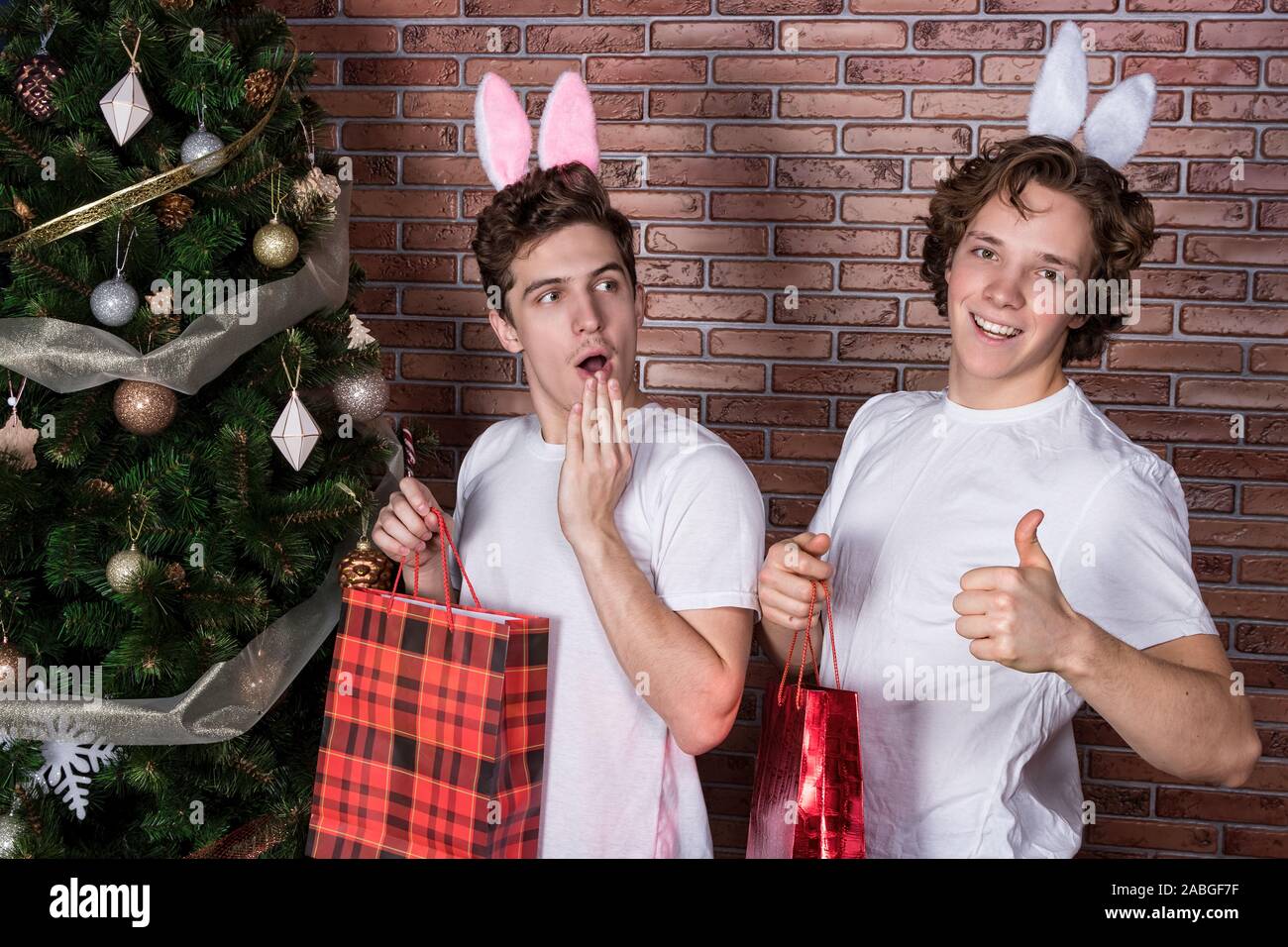Celebration. Two happy guys in suits rabbits Stock Photo - Alamy