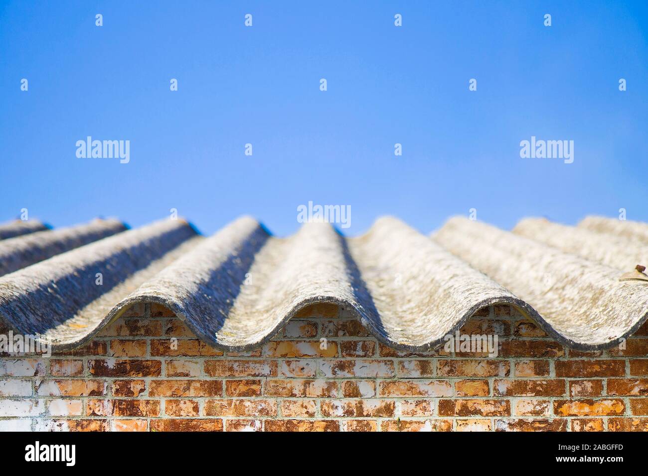 Dangerous asbestos roof over a brick wall - one of the most dangerous ...