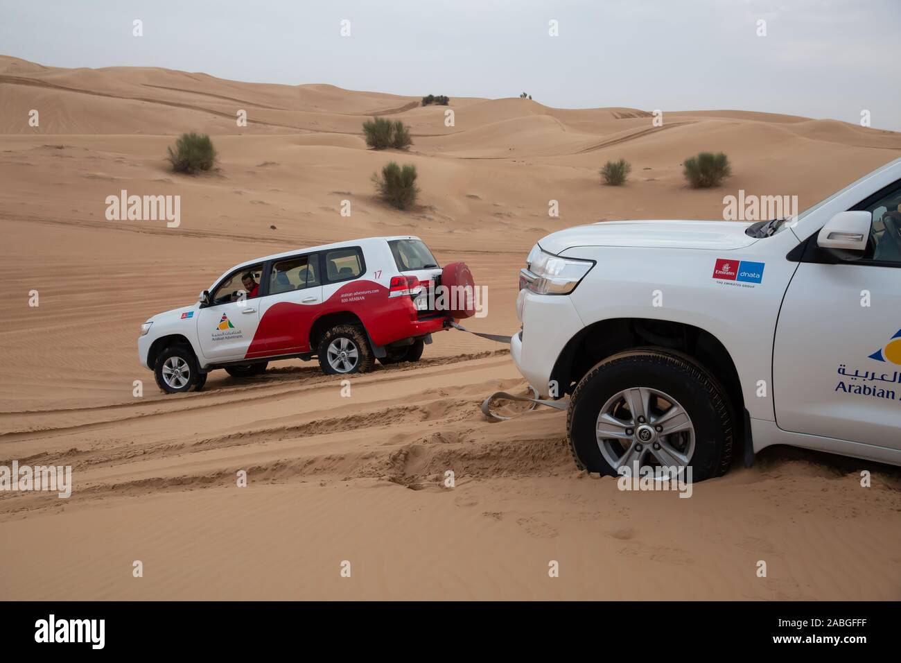 A 4X4 Land Cruiser helps tow another land cruiser which had become ...