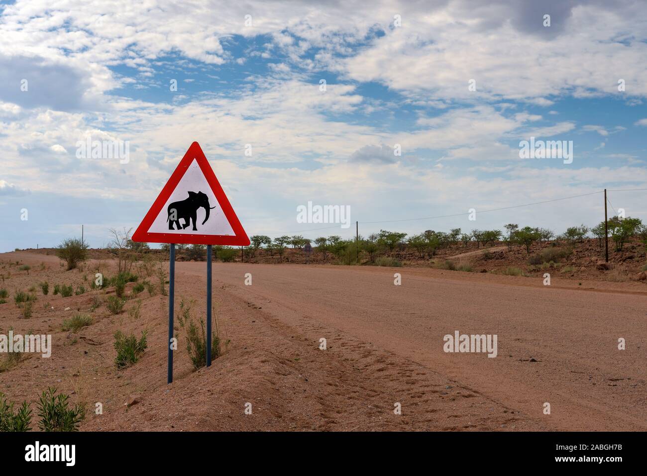 Elephant crossing warning road sign placed in the desert of Namibia ...