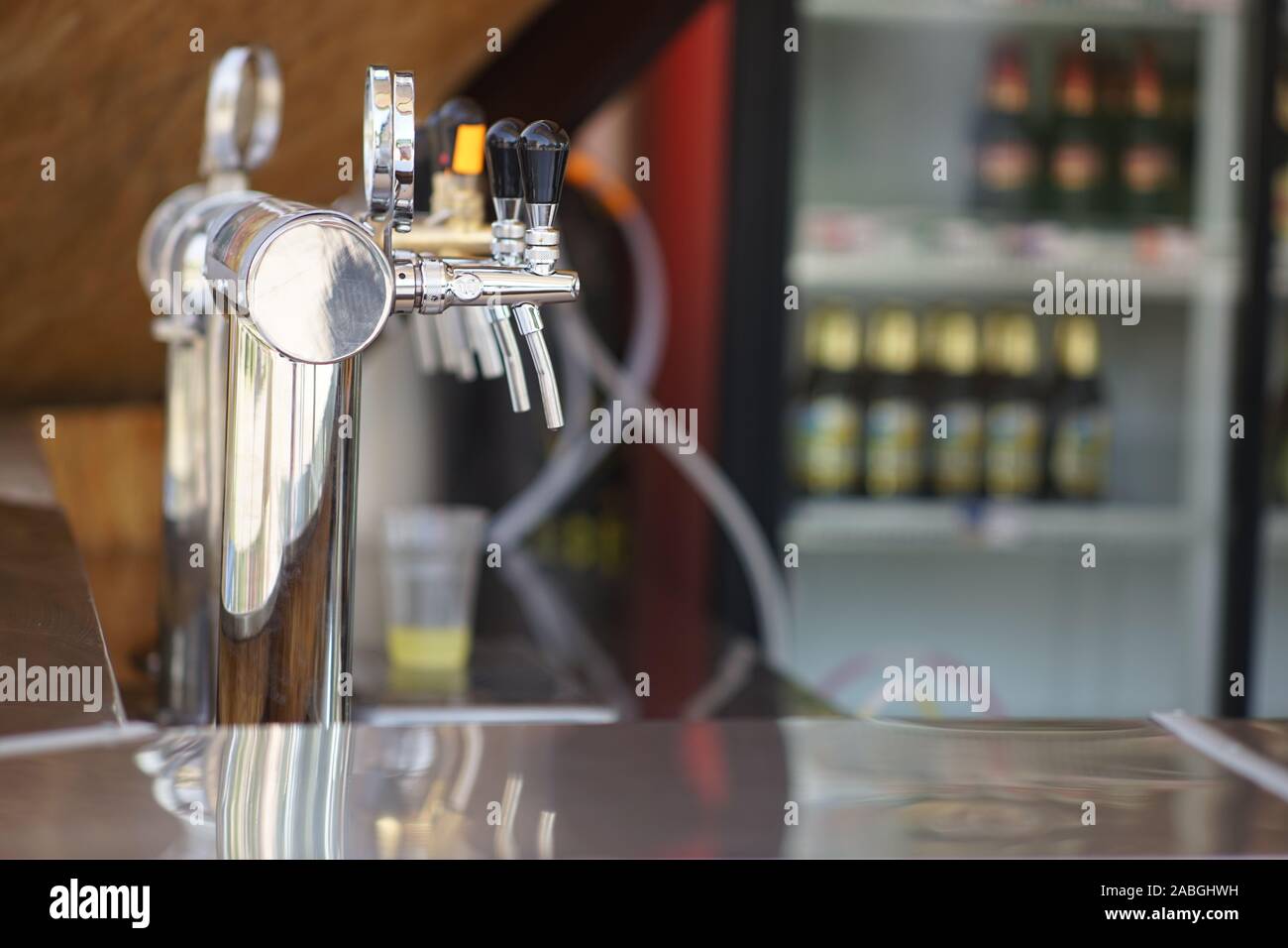 Chrome beer taps in a summer bar Stock Photo - Alamy