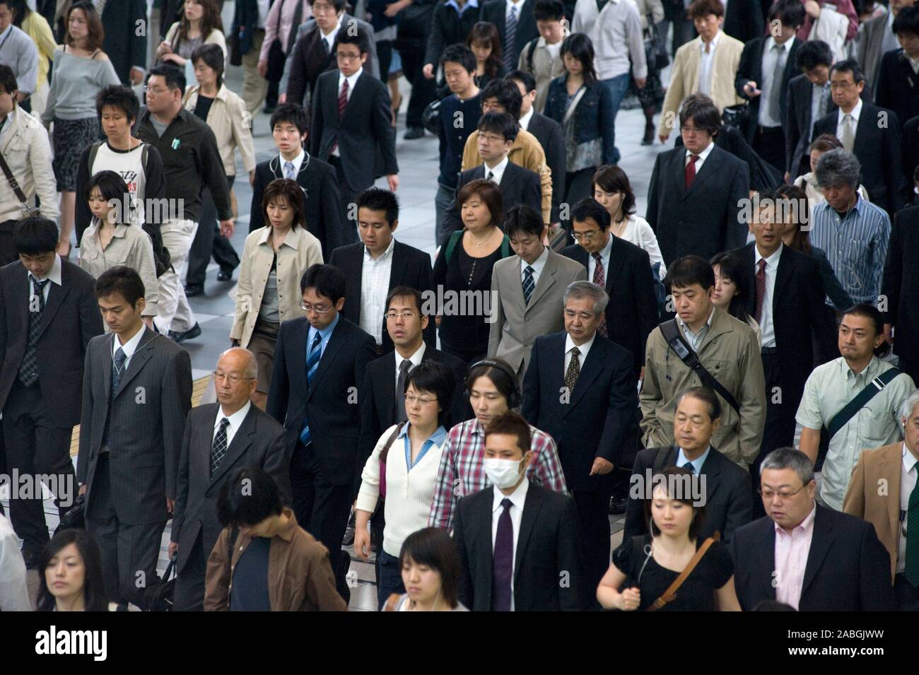 Crowds of commuters walking to work during morning rush hour in central ...