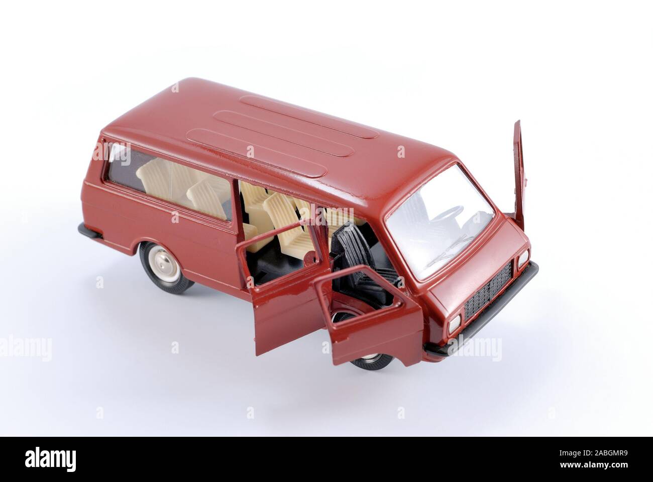 Reduced copy of a red passenger retro minibus car on a white background ...
