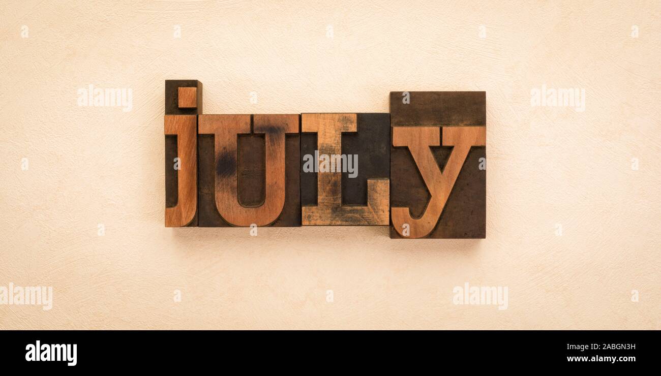 July, name of the month written with vintage letterpress printing ...