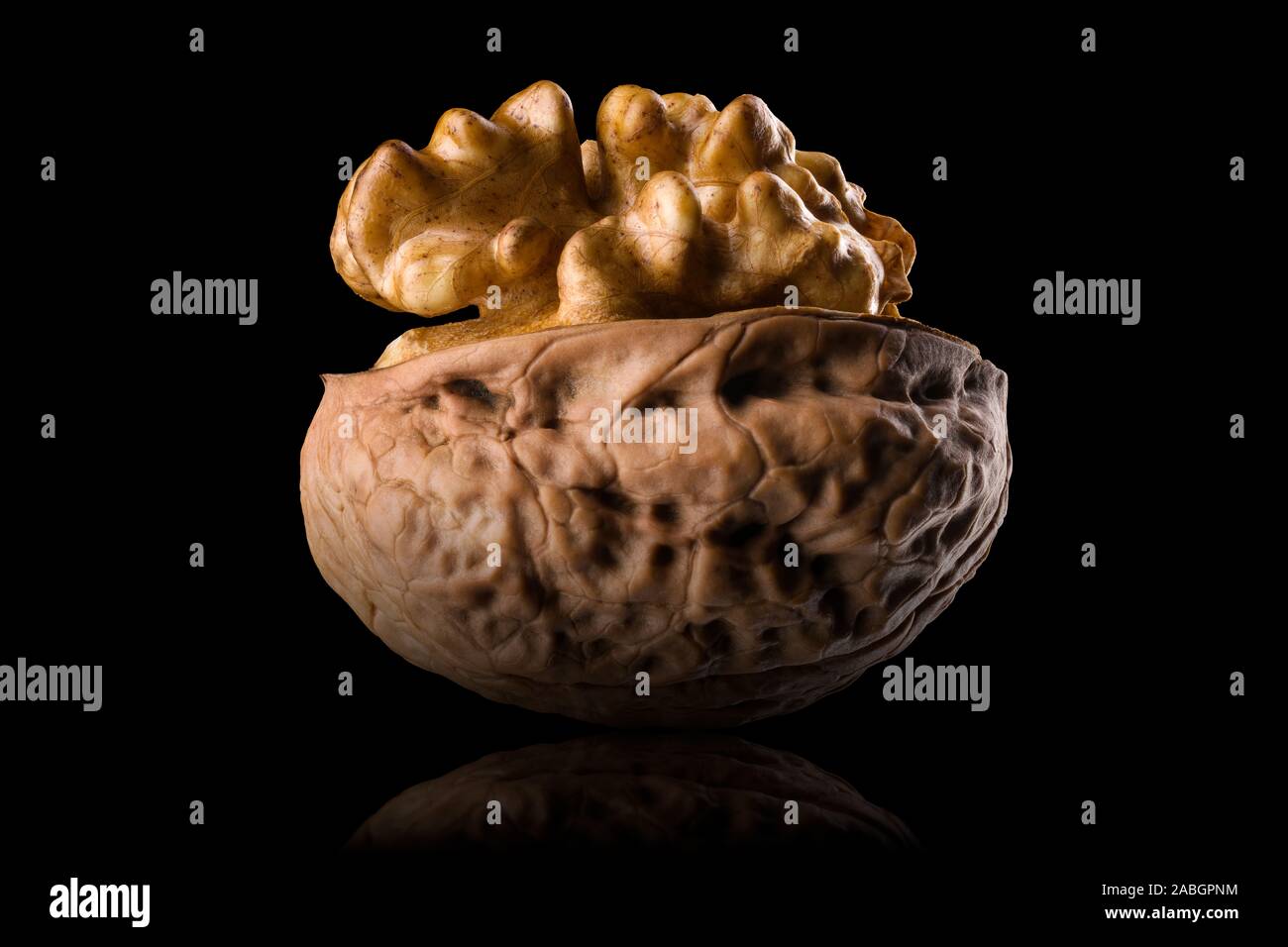 Half opened walnut with kernel isolated on a black background with ...