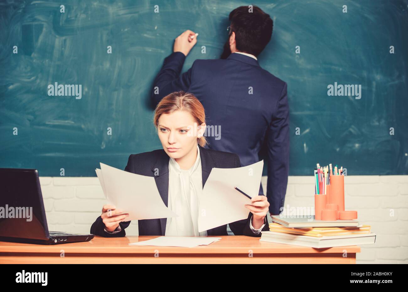 Write down your task. Teachers working in pairs school classroom ...