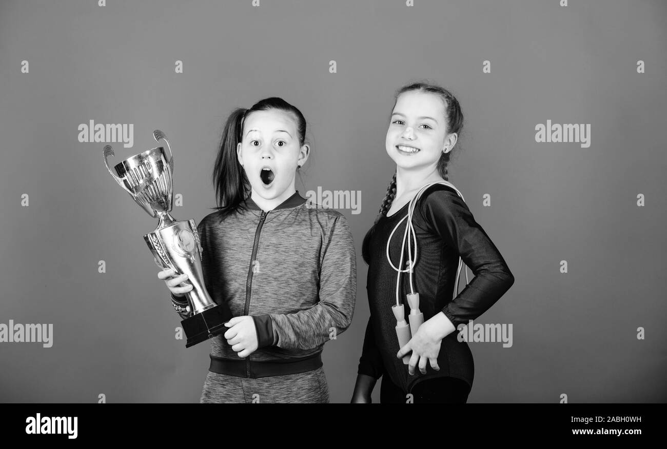 Deserved award. Sport achievement. Girls athletic kids celebrate ...