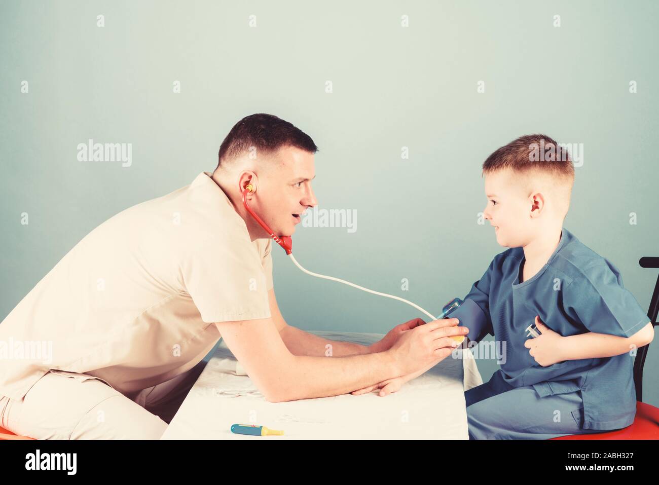 good team. happy child with father with stethoscope. nurse laboratory ...