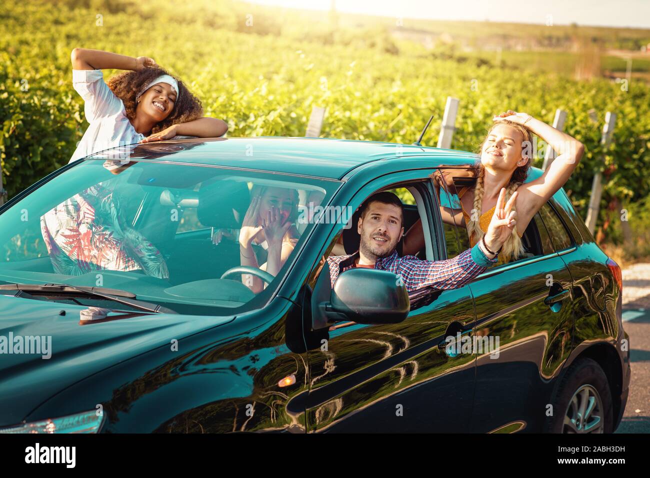 Friends enjoying a summer’s road trip together countryside. Women and ...
