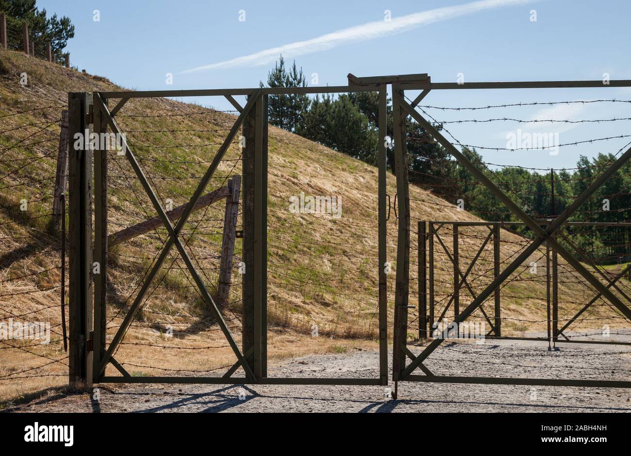 Opened double gates with barbed wire Stock Photo - Alamy