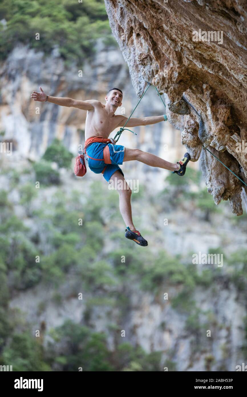 Man hanging on cliff hi-res stock photography and images - Alamy